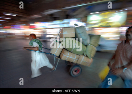 man dragging a fully loaded cart, Dubai City, United Arab Emirates ...