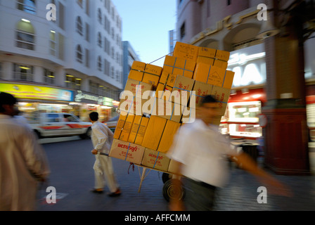 man dragging a fully loaded cart, Dubai City, United Arab Emirates ...