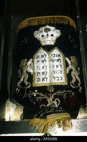 A richly embroidered mantle covers the sacred Torah Jewish scrolls ...