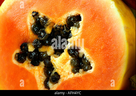 Cross section of a cut papaya with the fruit and the seeds. The Papaya ...