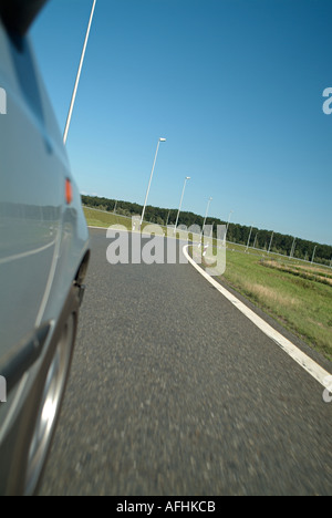 Car Speeding Down a Road, Low Angle Exterior View Stock Photo - Alamy