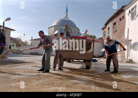 Men doing roadwork in front of mosque in small rural village in South ...