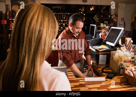 Business owner checking customers groceries Stock Photo - Alamy