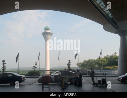 An air traffic control tower is seen through a window at Dulles ...