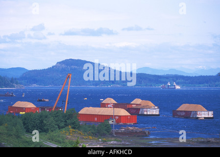 Logging barge on the Columbia River Gorge carrying logs and sawdust ...