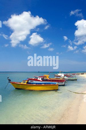 Red fishing boats in crystal clear water in the greek fishing village ...
