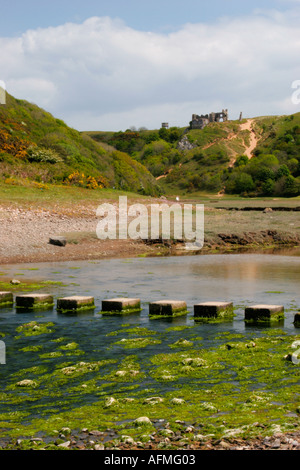 STEPPING STONES OVER PENNARD PILL WITH PENNARD CASTLE IN BACKGROUND ...
