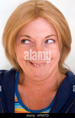 Blond middle aged Irish woman smiling and looking thoughtful Stock ...
