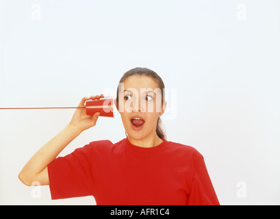 Western Woman Listening on String Telephone Stock Photo - Alamy