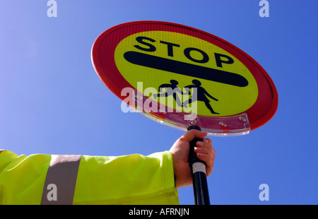 School Crossing Patrol Officer, aka Lollypop lady, holding Stop sign ...
