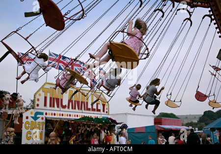 Kids on Chairoplanes ride at funfair at English village fete Stock ...