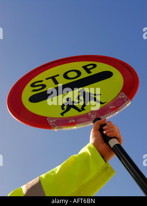 School crossing patrol woman with stop sign and police officer on the ...