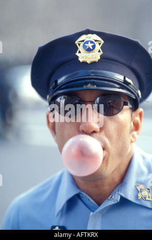 Police officer blowing gum Stock Photo - Alamy