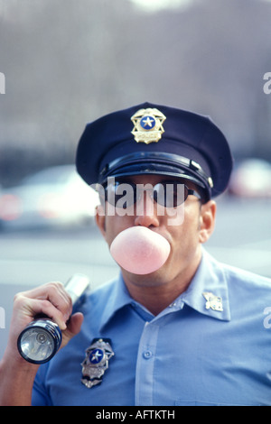 Police officer blowing gum Stock Photo - Alamy