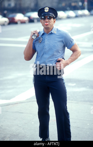 Police officer blowing gum Stock Photo - Alamy