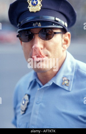Police officer blowing gum Stock Photo - Alamy
