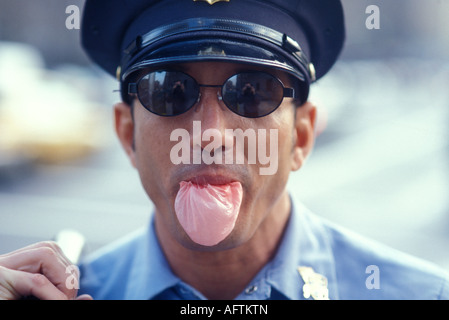 Police officer blowing gum Stock Photo - Alamy