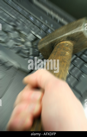 hitting laptop computer with a heavy hammer - computer frustration ...