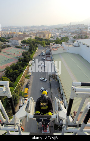 Fireman getting into firetruck Stock Photo - Alamy