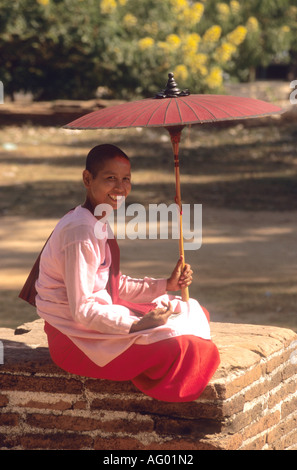Young nun with cross on pink background Stock Photo - Alamy