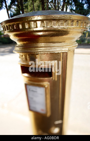 The gold-painted Victorian post box in the Cotswold village of Ampney ...