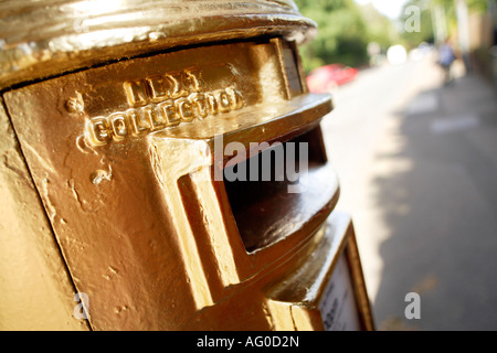 The gold-painted Victorian post box in the Cotswold village of Ampney ...