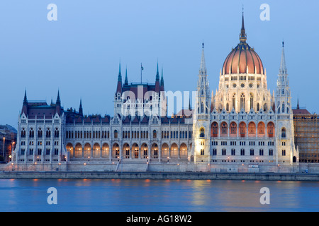 Neogothic parliament building with dome and towers, in front of a blue ...
