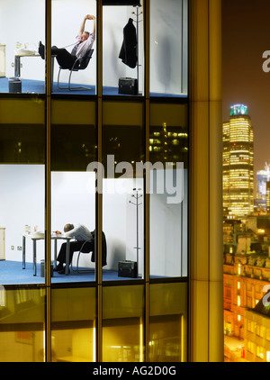 a man in the office, tired from work and shaggy, sits in front of a ...