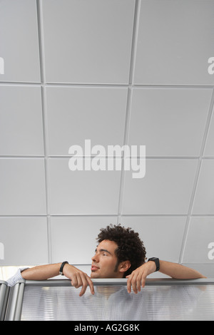Office worker peering over cubicle wall Stock Photo - Alamy