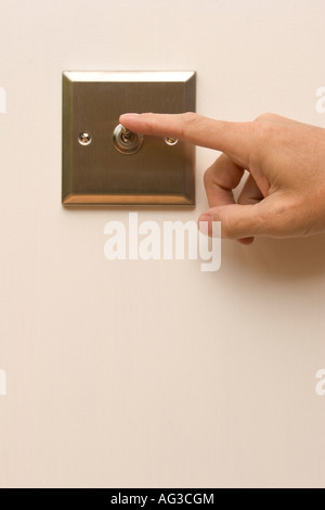Male hand switching off a wall mounted light switch Stock Photo - Alamy