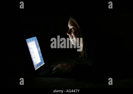 a girl using a laptop computer in bed looking sad and depressed Stock ...