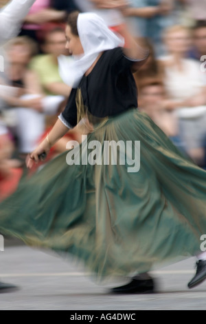 Female Basque folk dancer wearing blue shawl and red hair ribbon fiesta ...