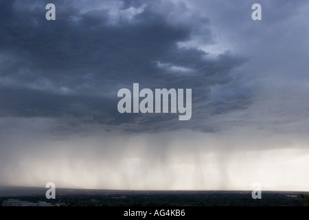 Rain and thunder storm seen approaching from a distance Stock Photo - Alamy