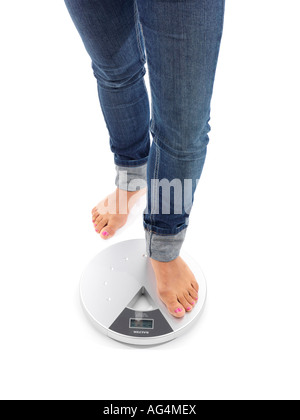 Teenager dieting. Teenage girl using a tape measure to measure the ...