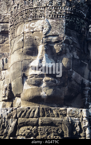 Giant stone face of ancient Bayon temple. Bayon temple nestled in ...