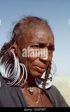 Fula (Peul) woman wearing traditional Fulani golden earrings and a nose ...