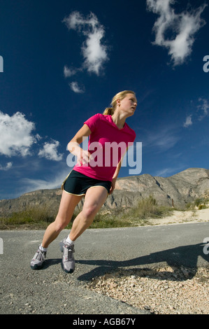 Female runner on scenic road Stock Photo - Alamy