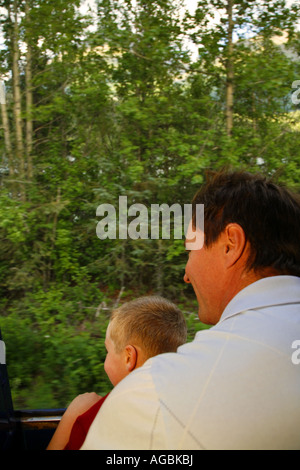 Fun with dad on the railroad. a father and son playing with a toy train ...