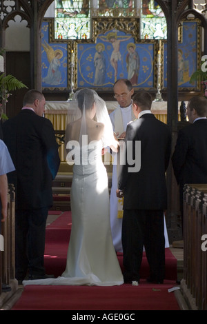 Bride at the alter with her Groom make their wedding vows in St George ...