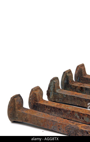Two very old and rusty railroad spikes isolated on white background ...