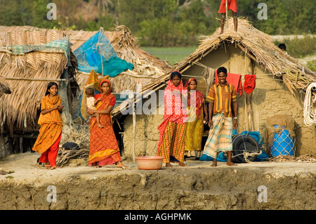 Poor fishing village and thached roof mud houses along Passur River ...