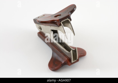 Used staple remover against a white background Stock Photo - Alamy