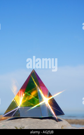 Glass pyramid with light rays reflected prism like Stock Photo - Alamy