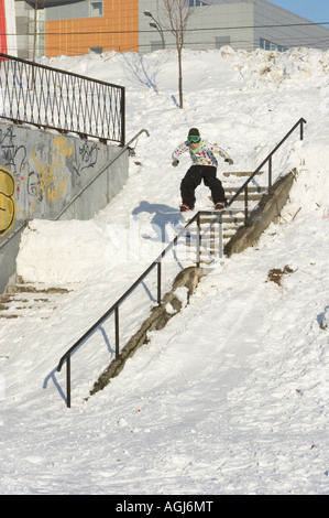 Jibbing snowboard in the city 8 Stock Photo - Alamy