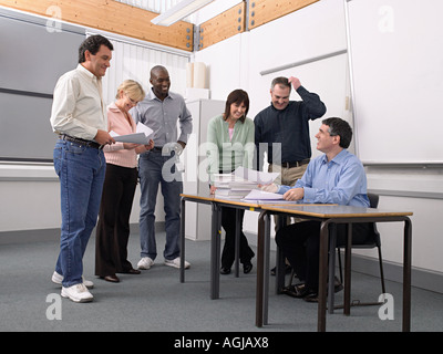 Mature students looking at papers Stock Photo - Alamy