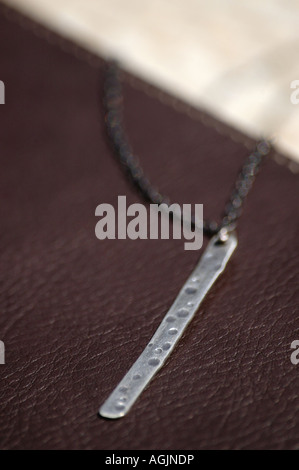 Necklace made of a sterling silver piece randomly hammered Stock Photo ...