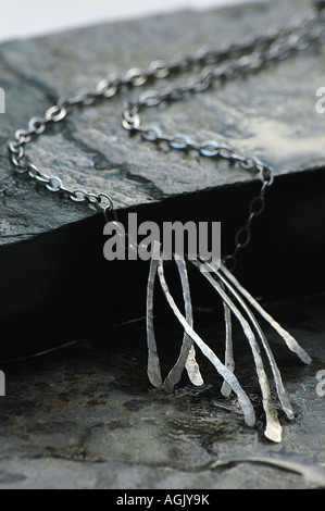 Necklace made of a sterling silver piece randomly hammered Stock Photo ...