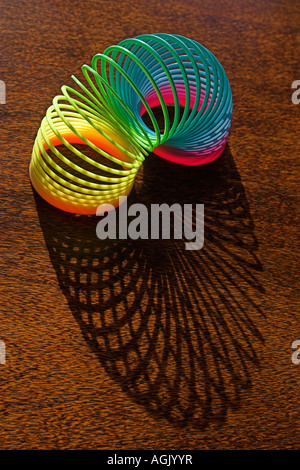 Colourful plastic Slinky toy on white background Stock Photo - Alamy