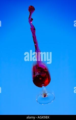 Glass of Wine Falling Mid Air with Spill Stock Photo - Alamy
