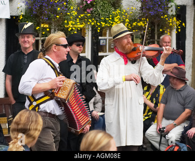 Morris dancers dressed in traditional costumes wave handkerchiefs in ...